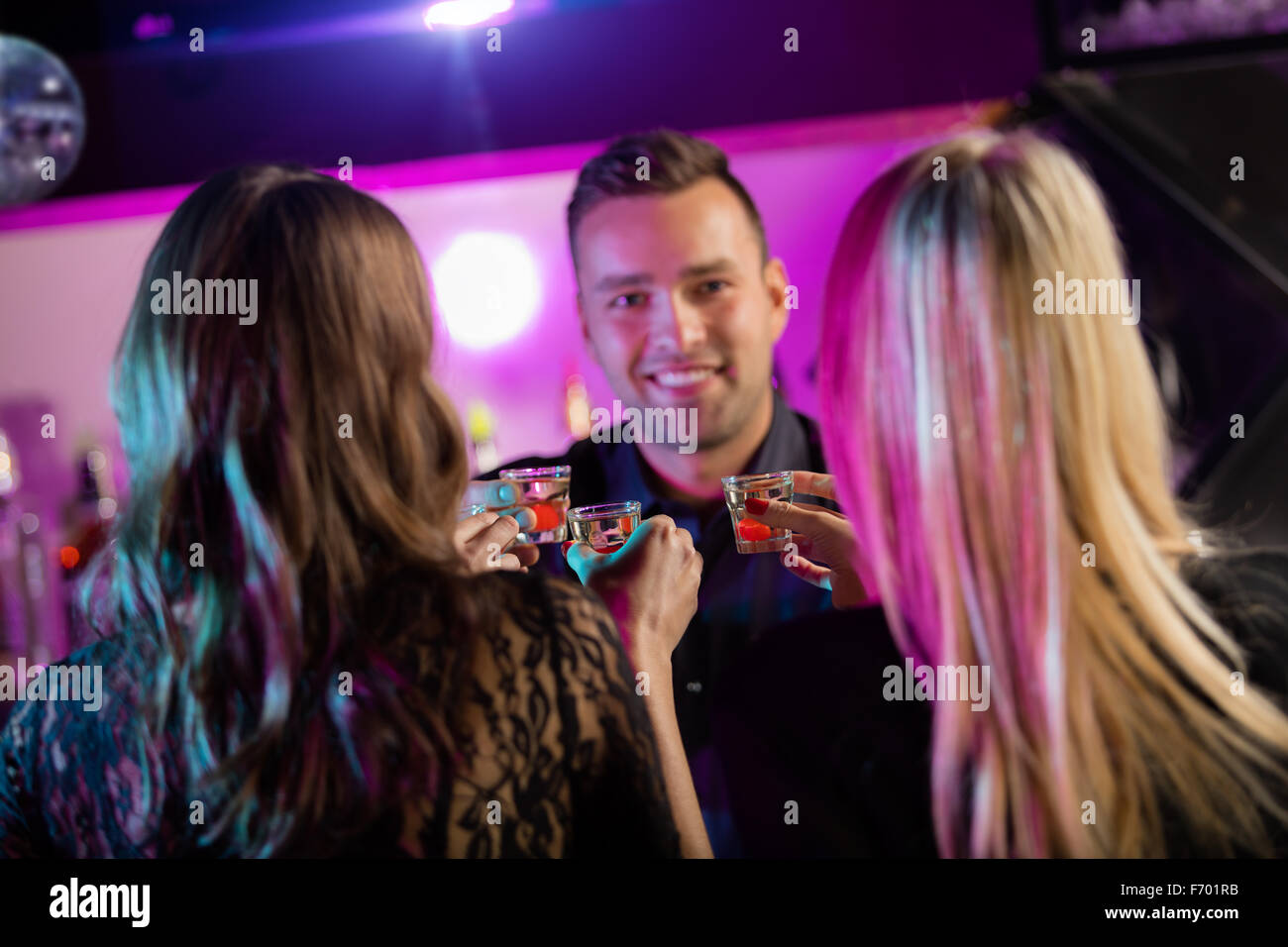 Friends drinking shots together Stock Photo - Alamy