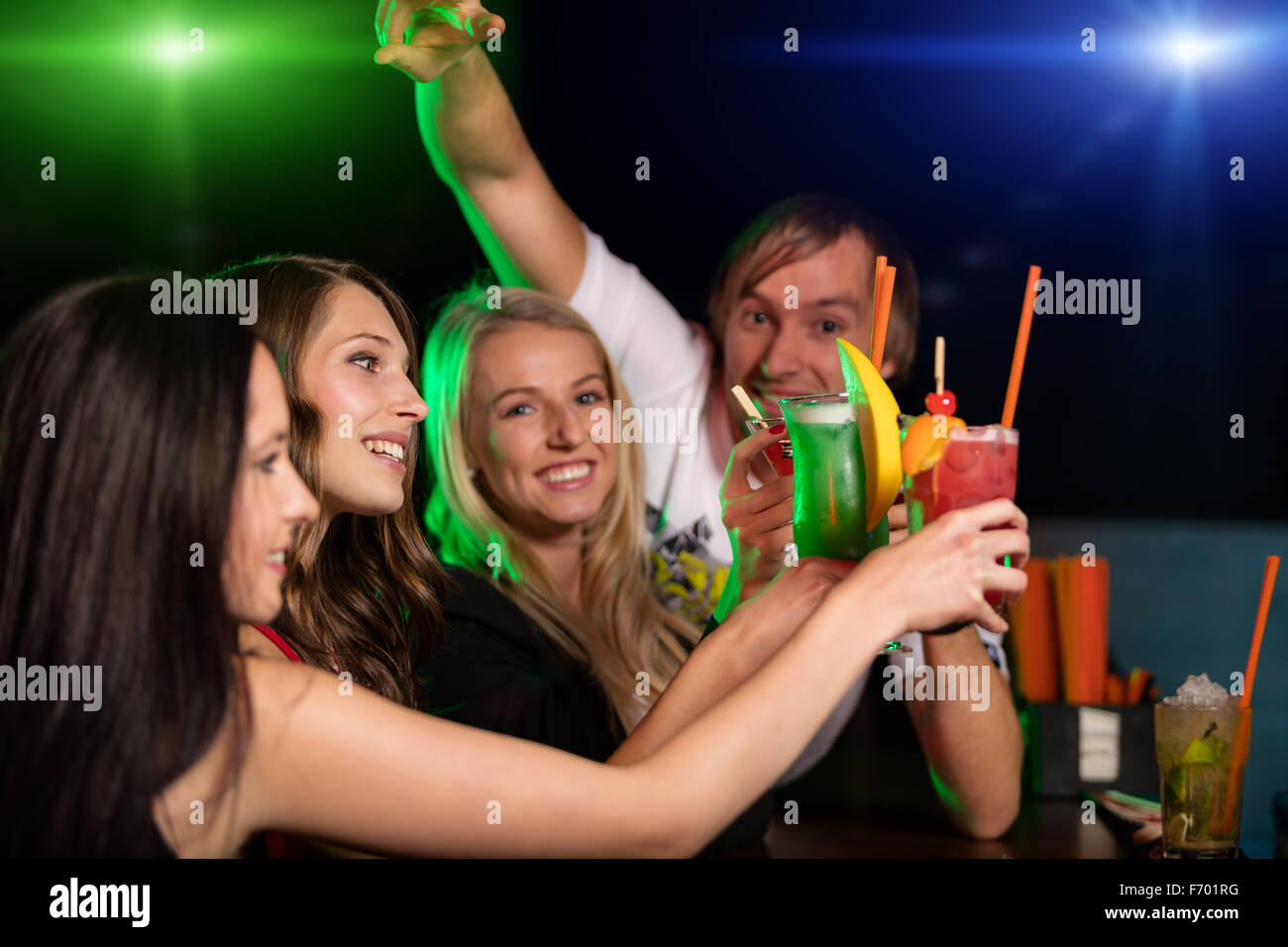 Young friends drinking cocktails together at party Stock Photo - Alamy