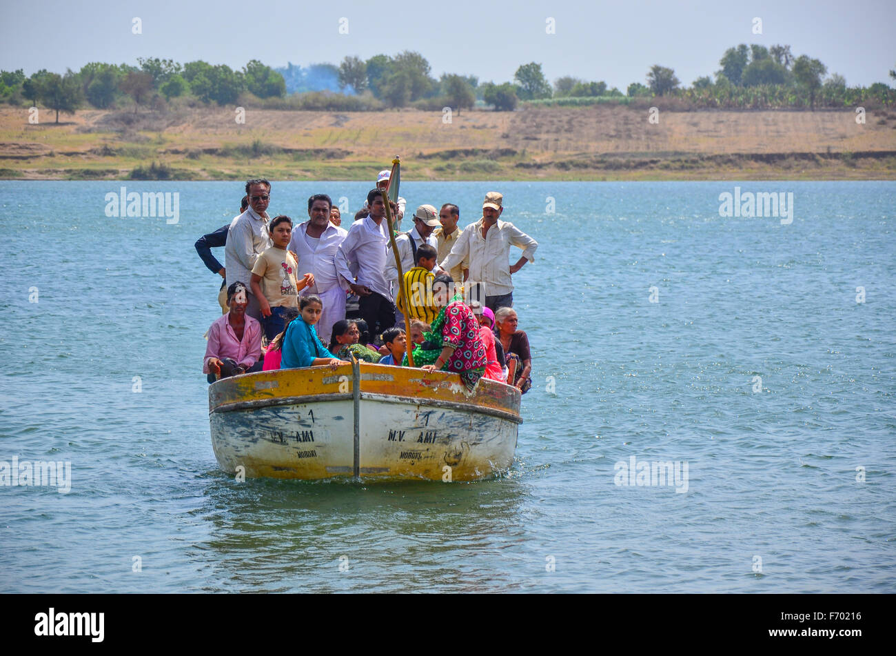 A boat carrying lots of people plying on Narmada river at Nareshwar ...