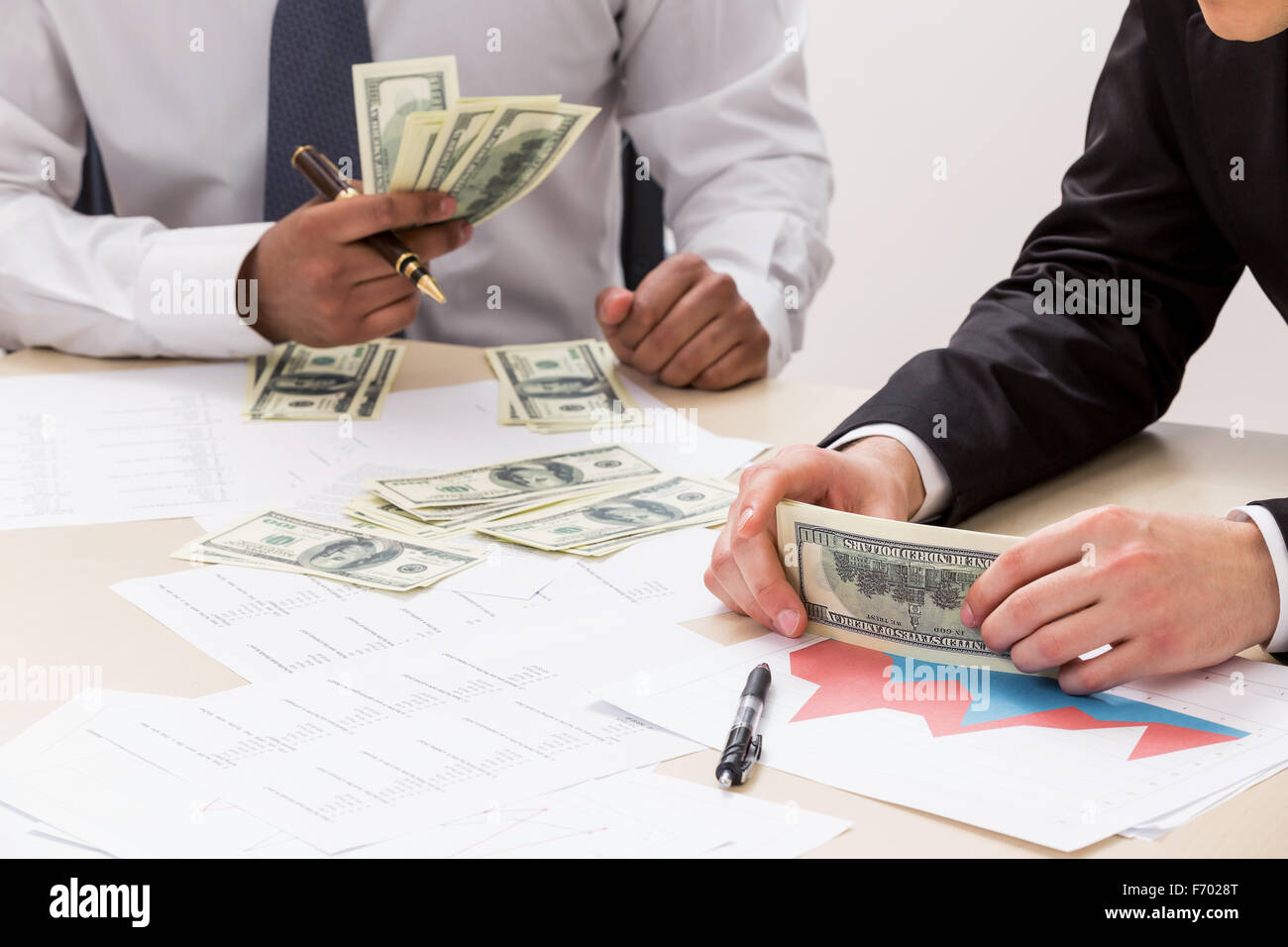 Successful guys count money Stock Photo - Alamy