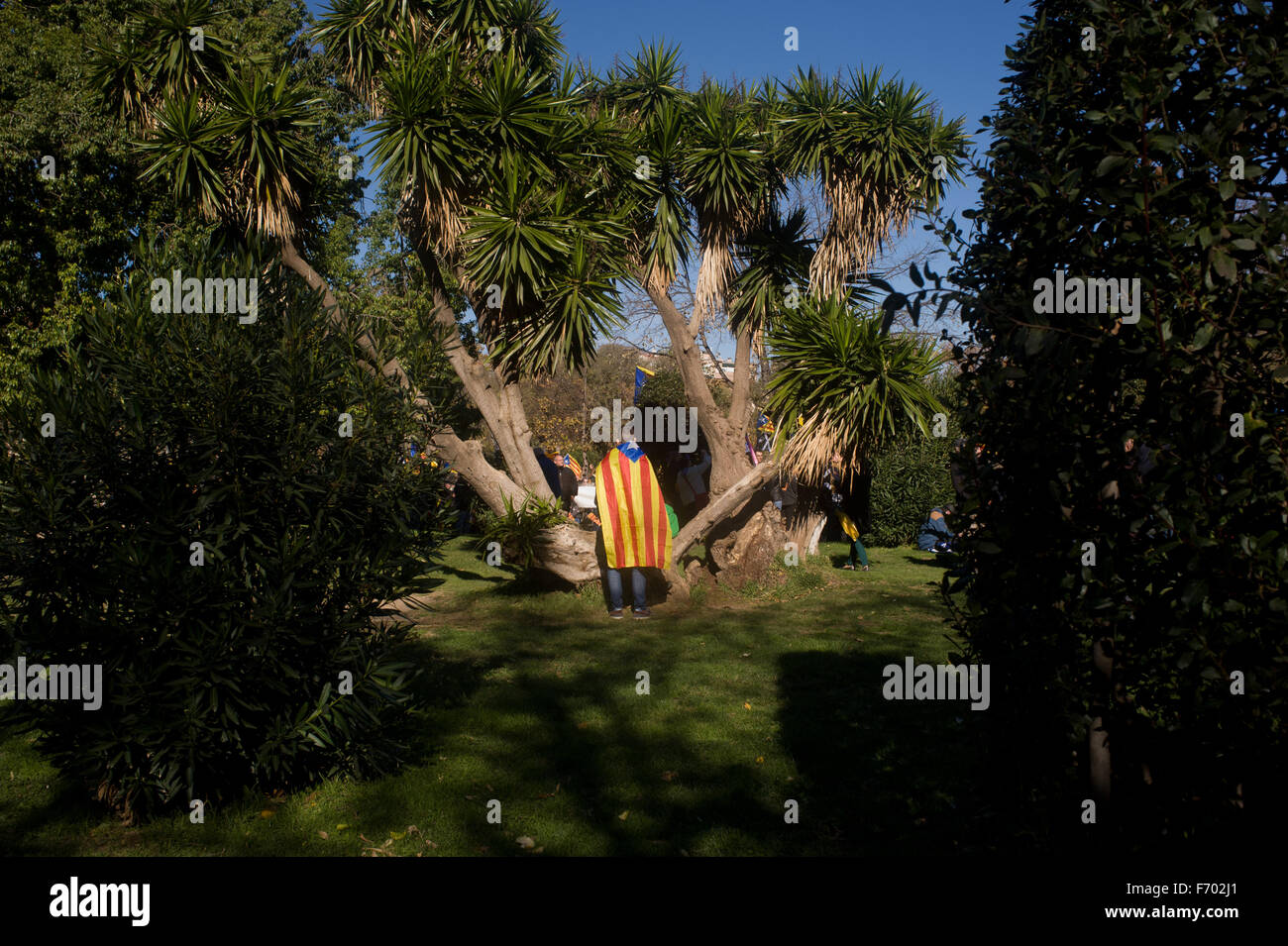 A man is seen carrying a estelada flag (symbol of catalan independence ...