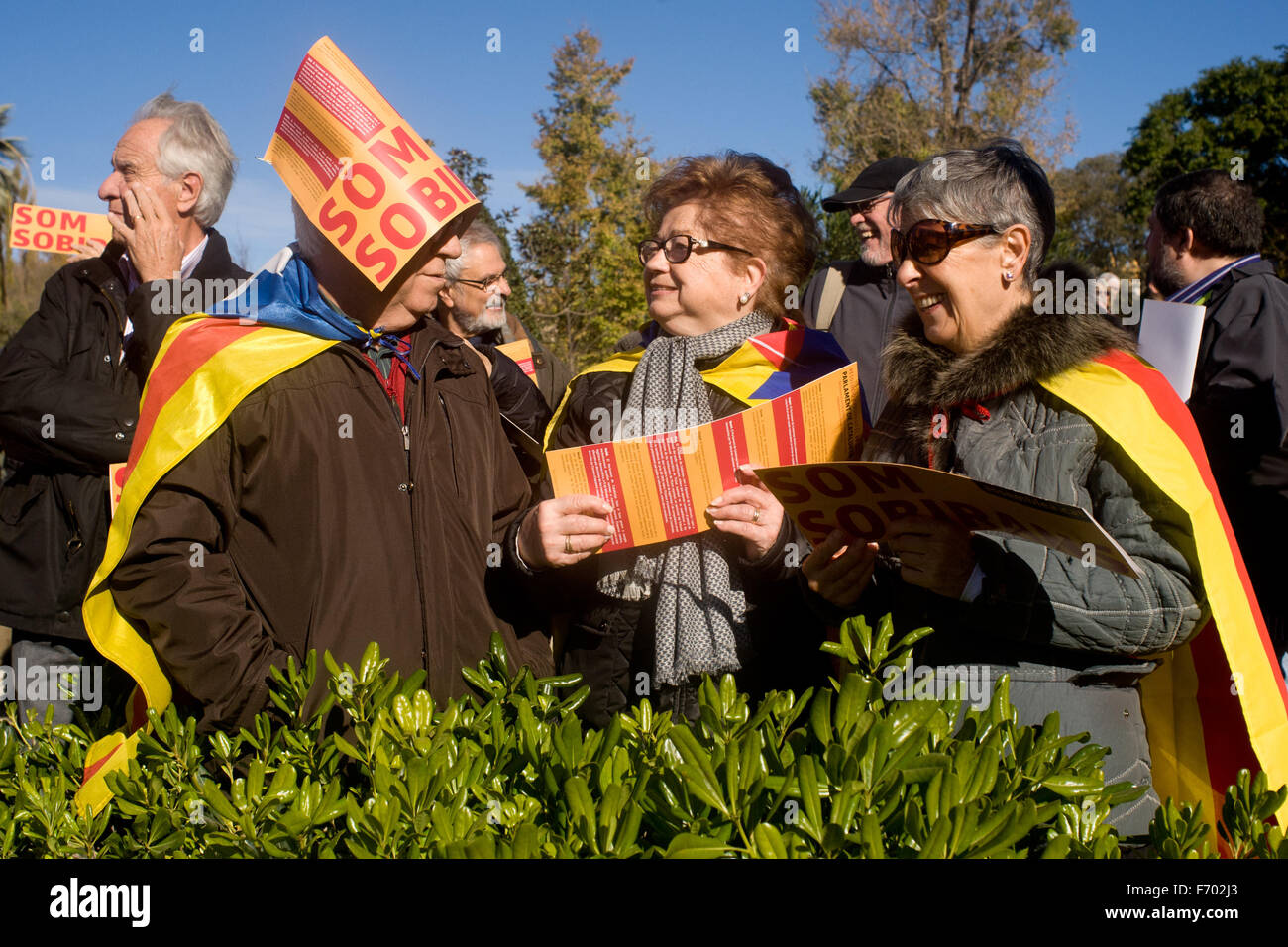 People is seen carrying estelada flags (symbol of catalan independence ...