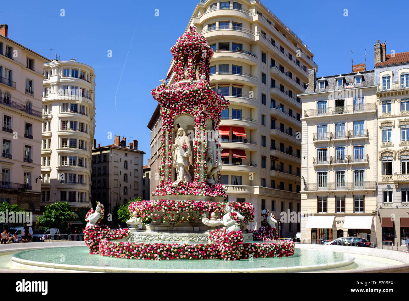 Fountain covered in flowers in Place des Jacobins, Lyon, France Stock ...