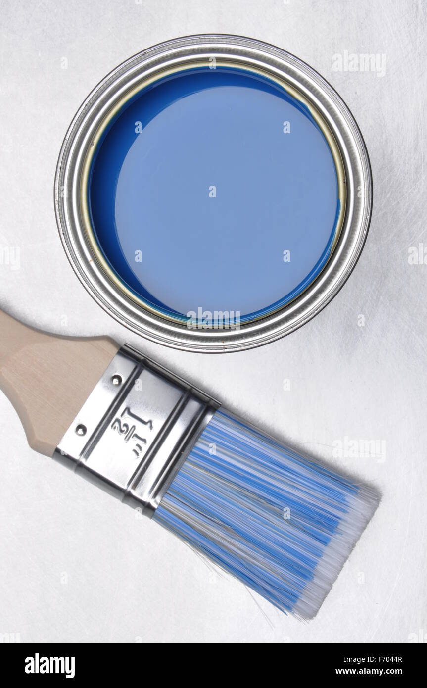 Top view of blue paint can with brush on grey metal background Stock ...