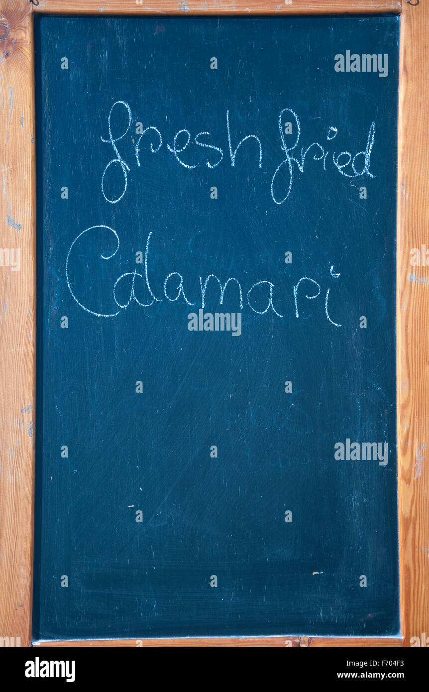 Sign of a restaurant that shows fresh squid calamari Stock Photo - Alamy