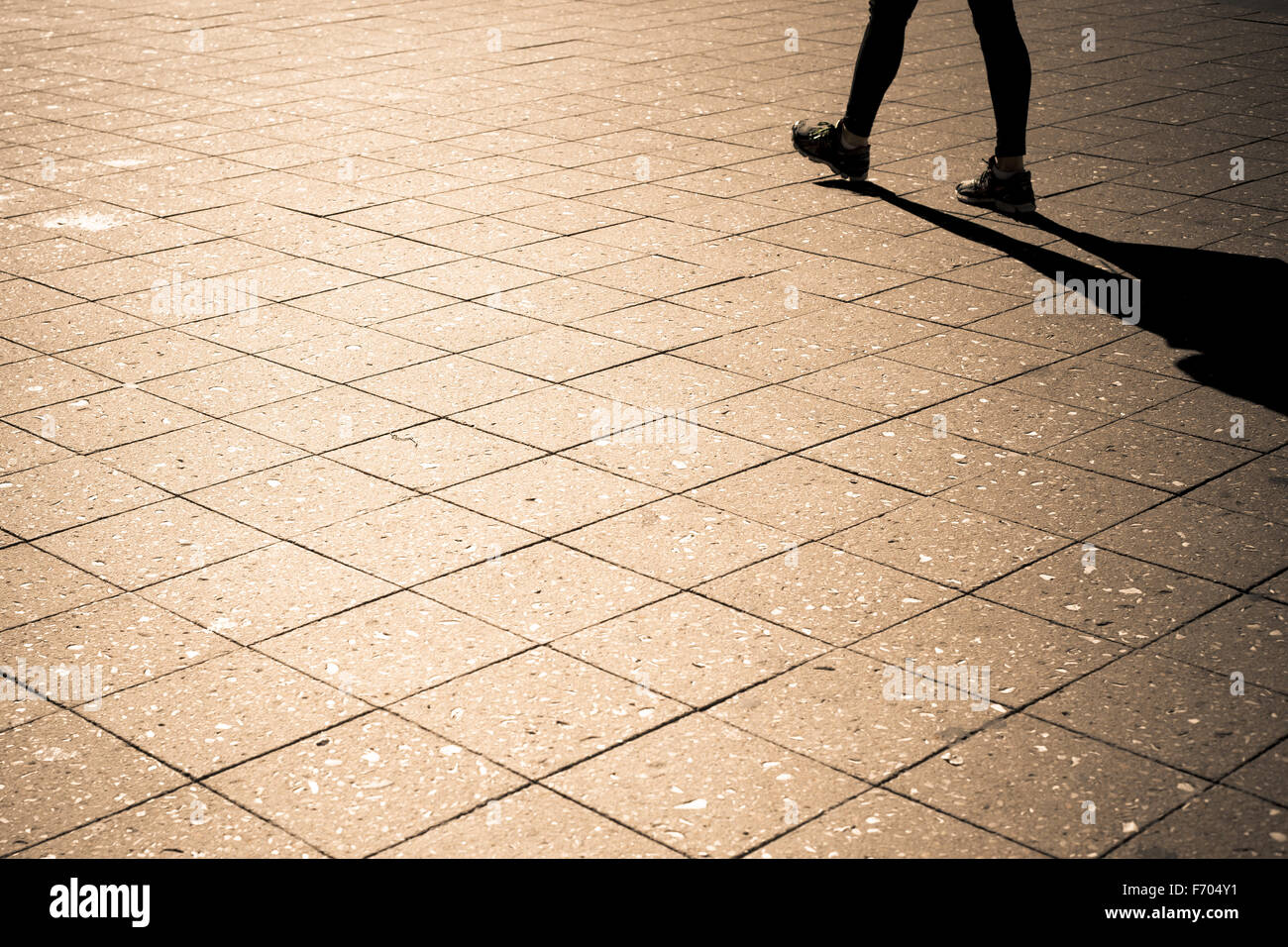 Minimalist image of person and shadow walking outdoors Stock Photo - Alamy