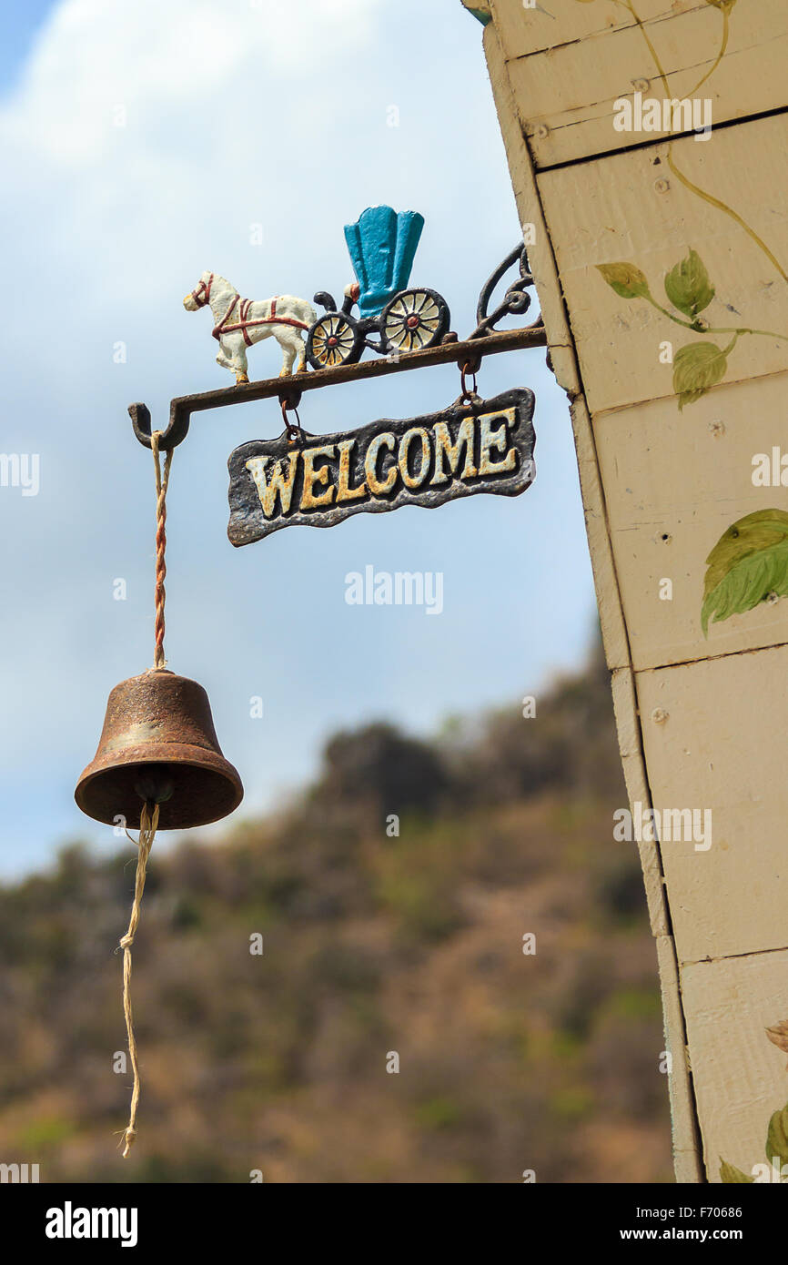 Metal sign welcome bell with carriage sculpture Stock Photo - Alamy