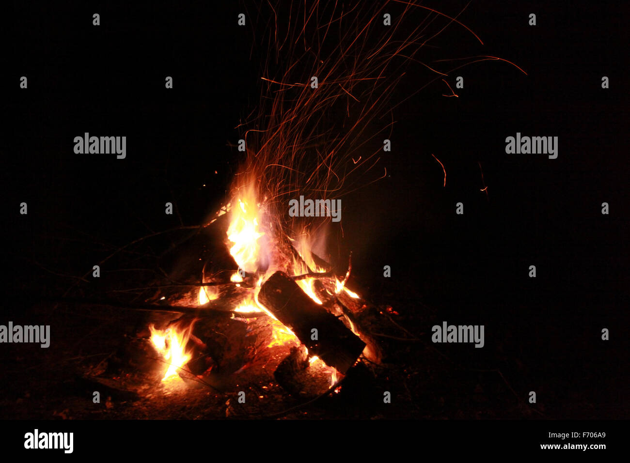 People standing around a bonfire at a family gathering on thanksgiving ...