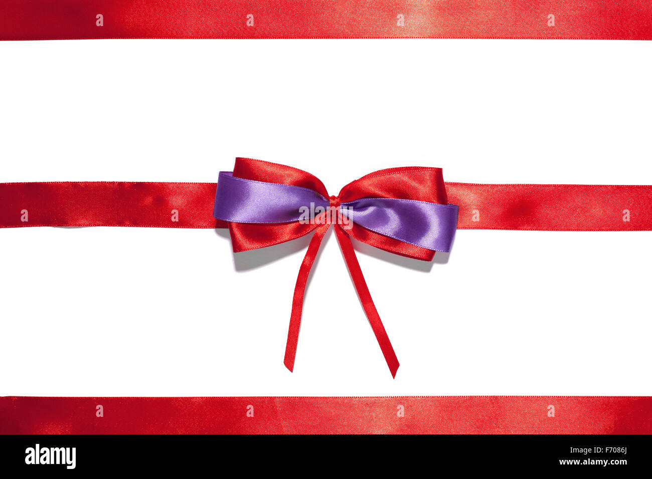 Red ribbon with bow on white Stock Photo - Alamy