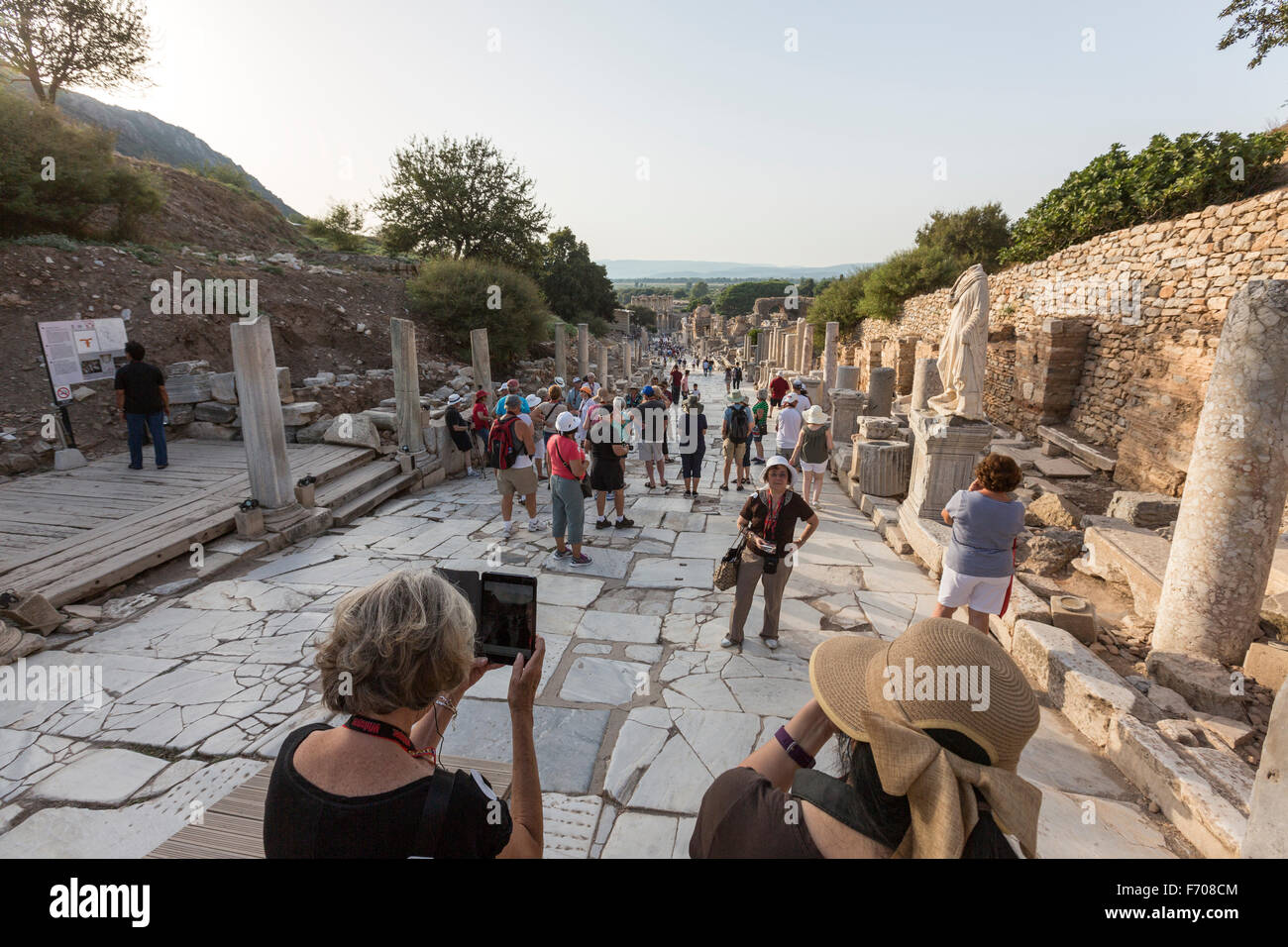 Tourists taking pictures in Curetes street, Ephesus an ancient Greek ...