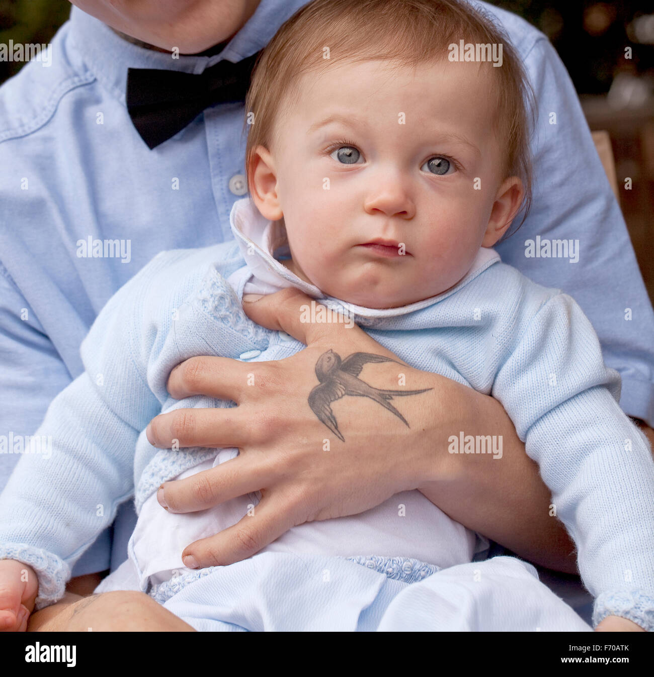 My Father's Hand. A young baby boy is being held lovingly by his father ...
