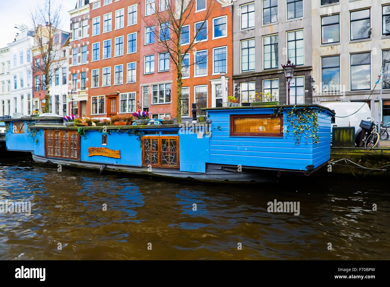 Image of a colourful blue houseboat on a Amsterdam canal Stock Photo ...