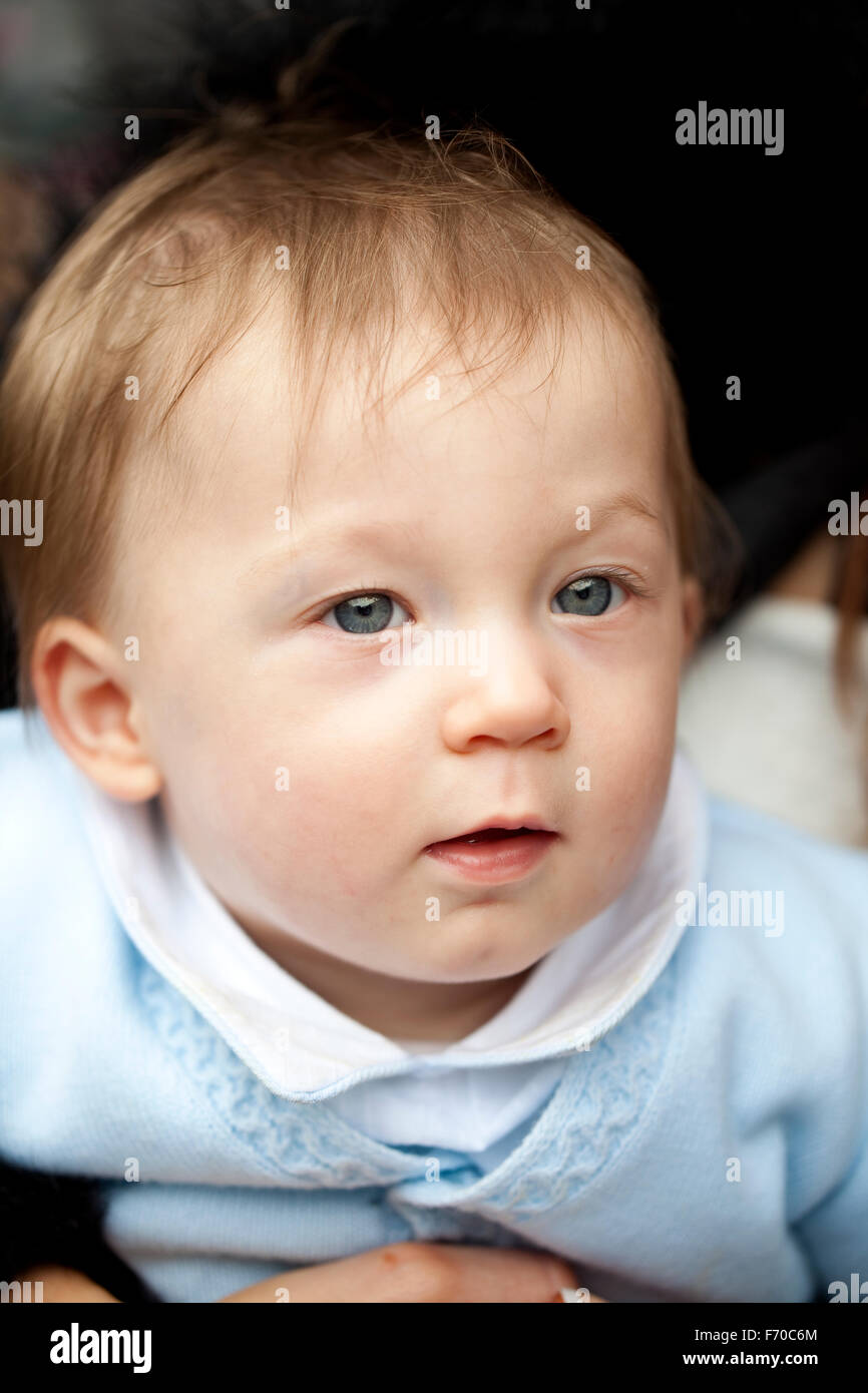 Baby Boy. A head shot of a baby boy who is looking at something out of ...