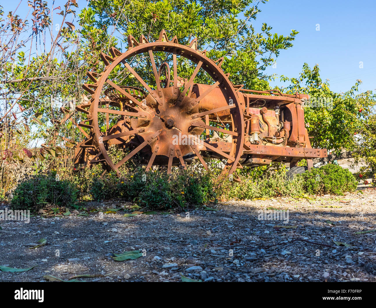 An antique abandoned deteriorated tractor rusting away in a field in ...