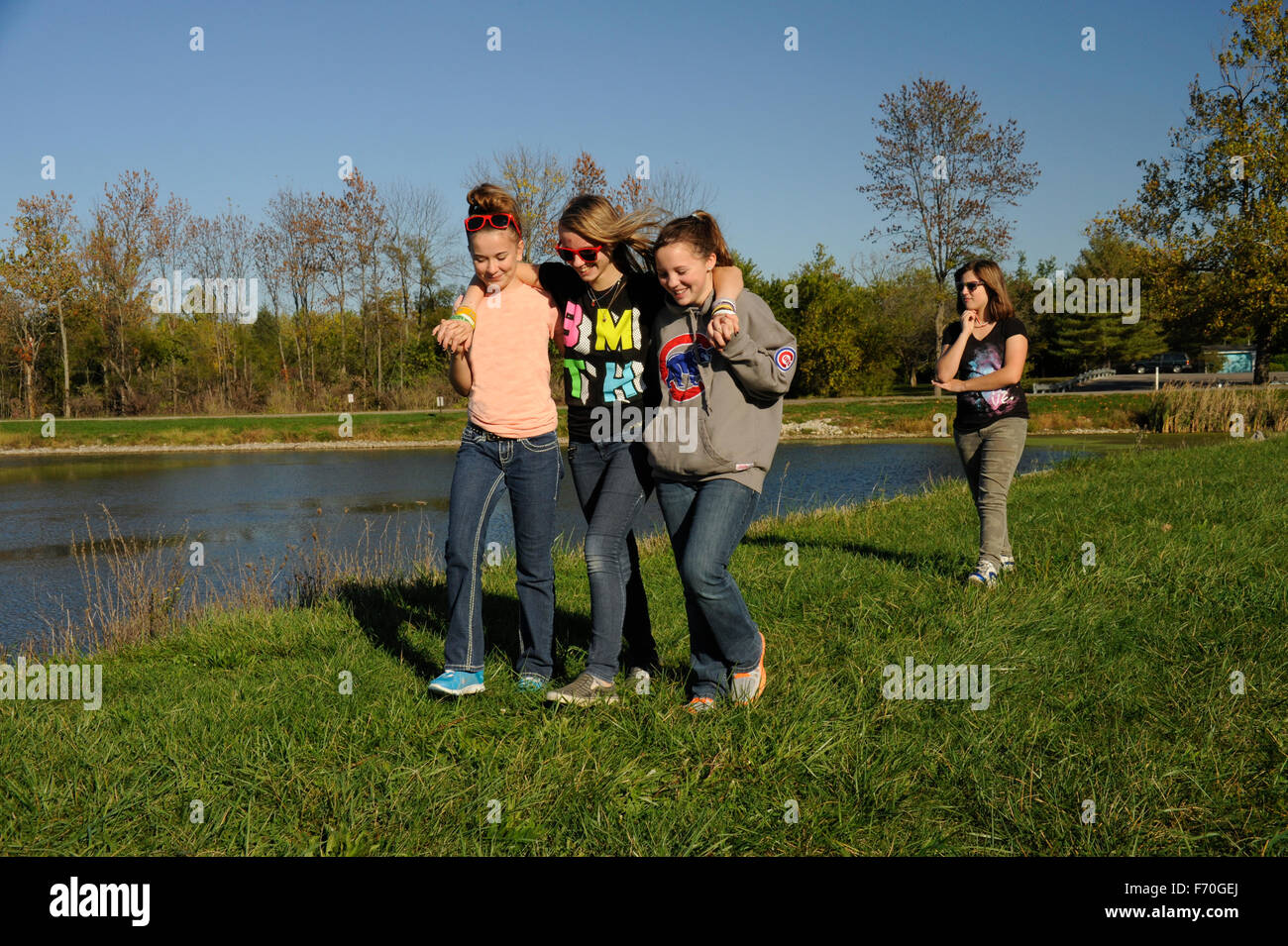 Three teen girls ignoring one girl Stock Photo - Alamy