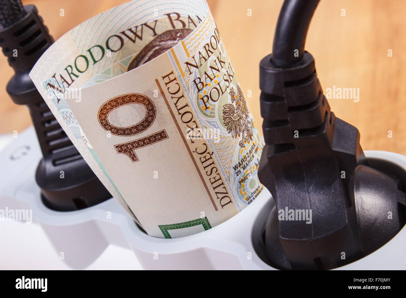 Electrical extension with connected plug and polish currency money on ...