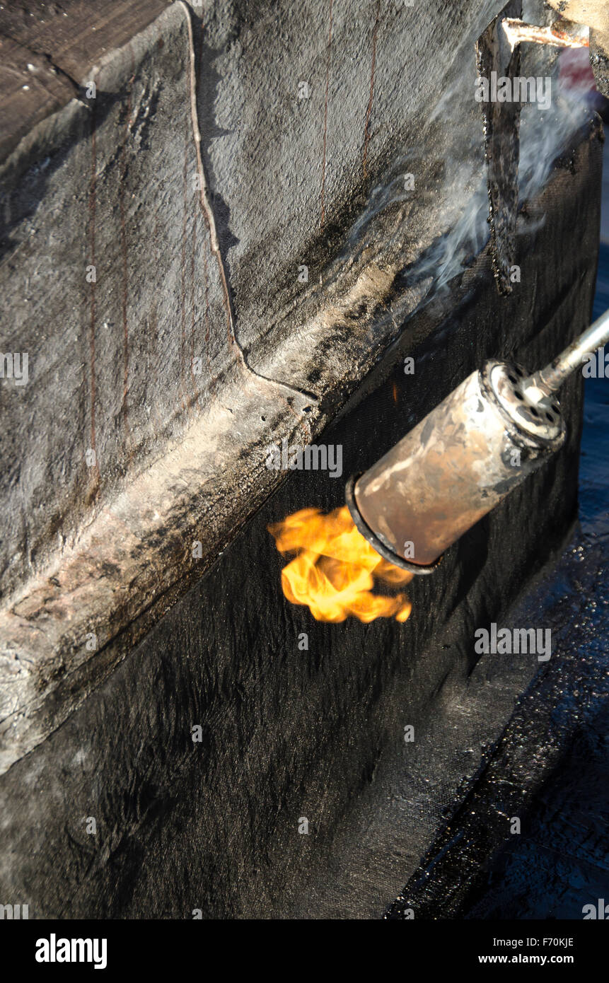 flame during welding of a waterproofing membrane on a roof Stock Photo ...
