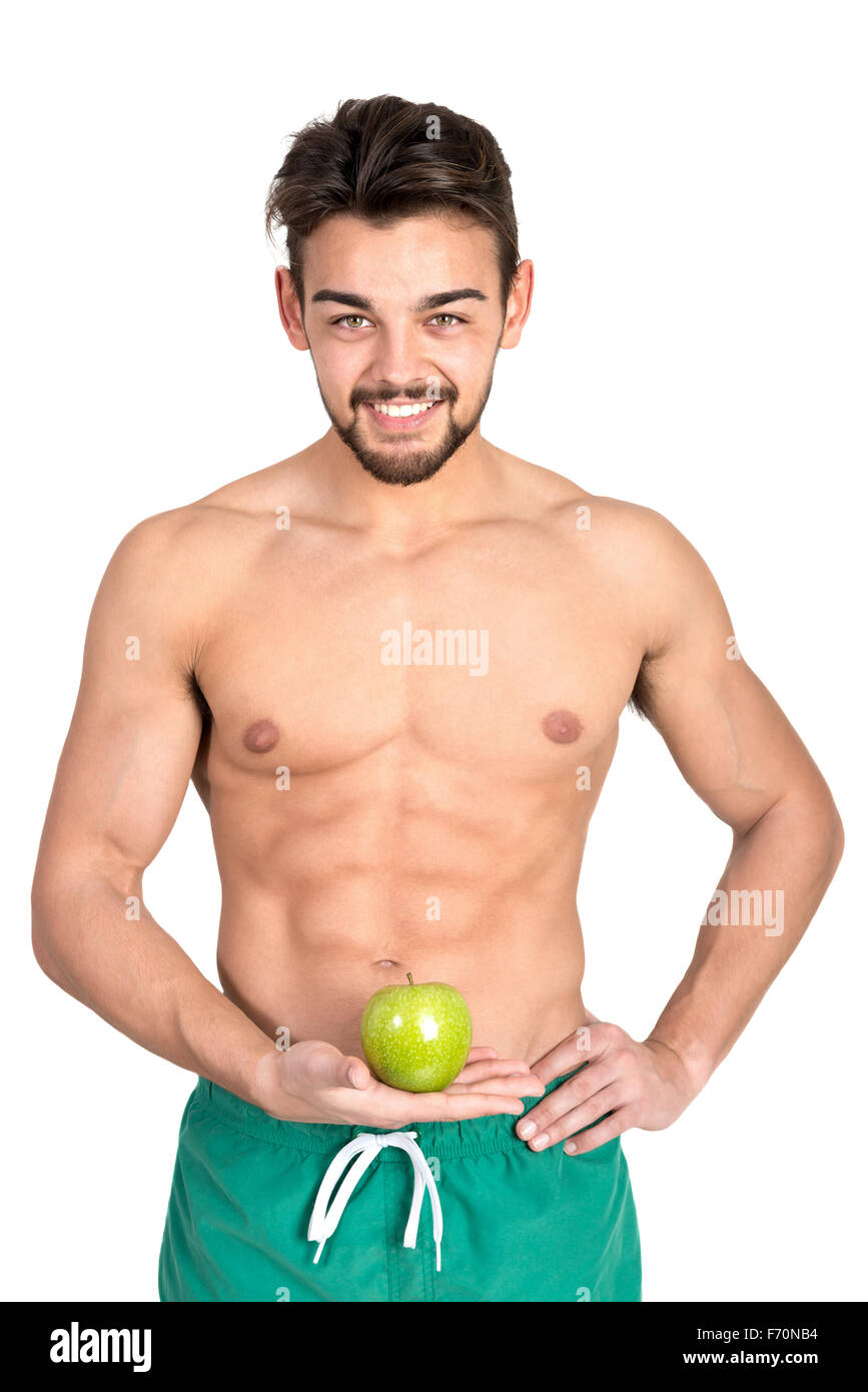 Handsome and fit young man with an apple isolated in white Stock Photo ...