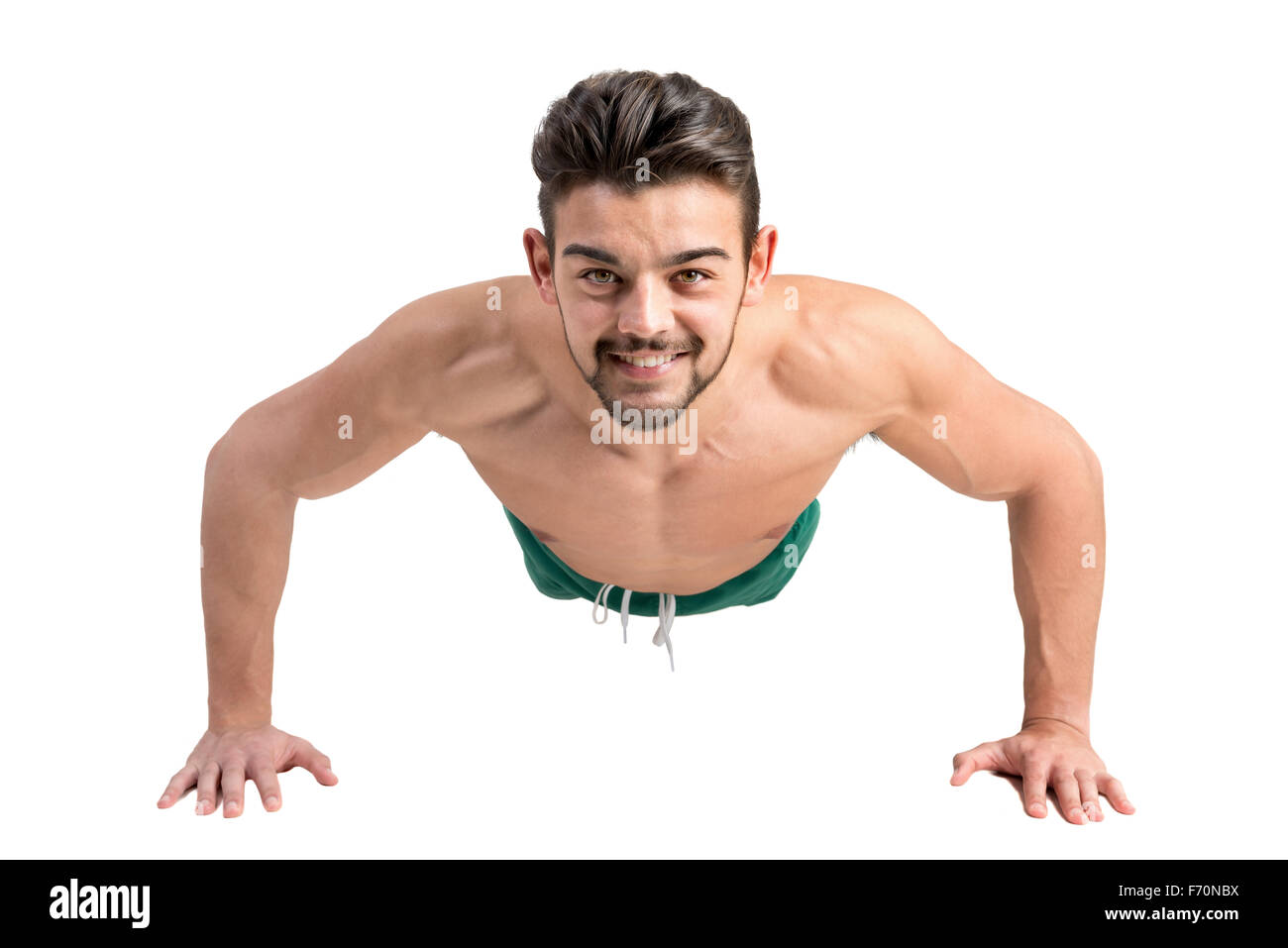 Handsome and fit young man doing push ups isolated in white Stock Photo ...