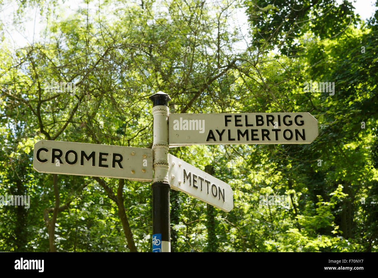 Old retro style road traffic sign with directions to Cromer, Metton ...