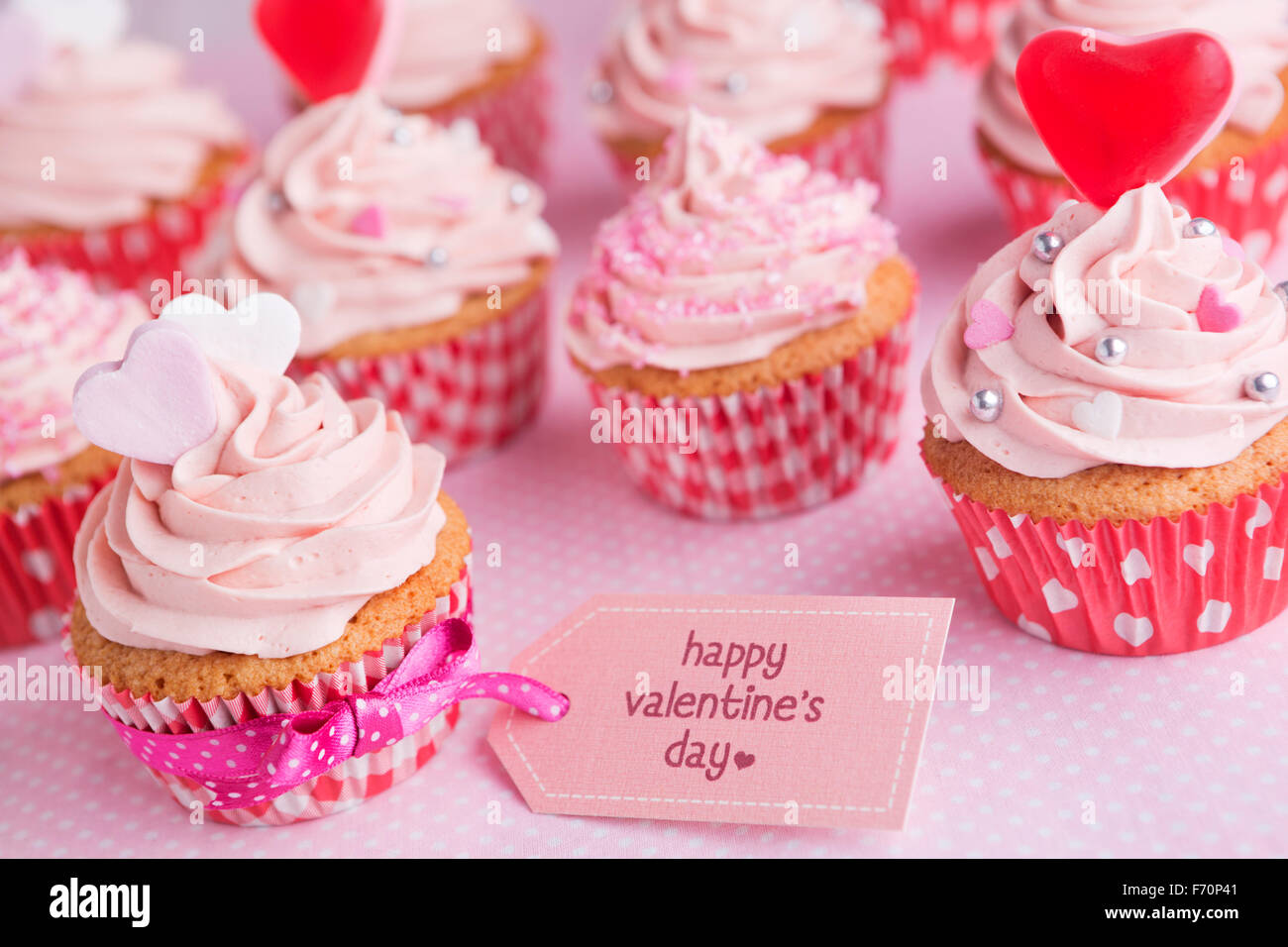 Pink Valentine cupcakes with the words 'Happy Valentine's day' on a tag ...