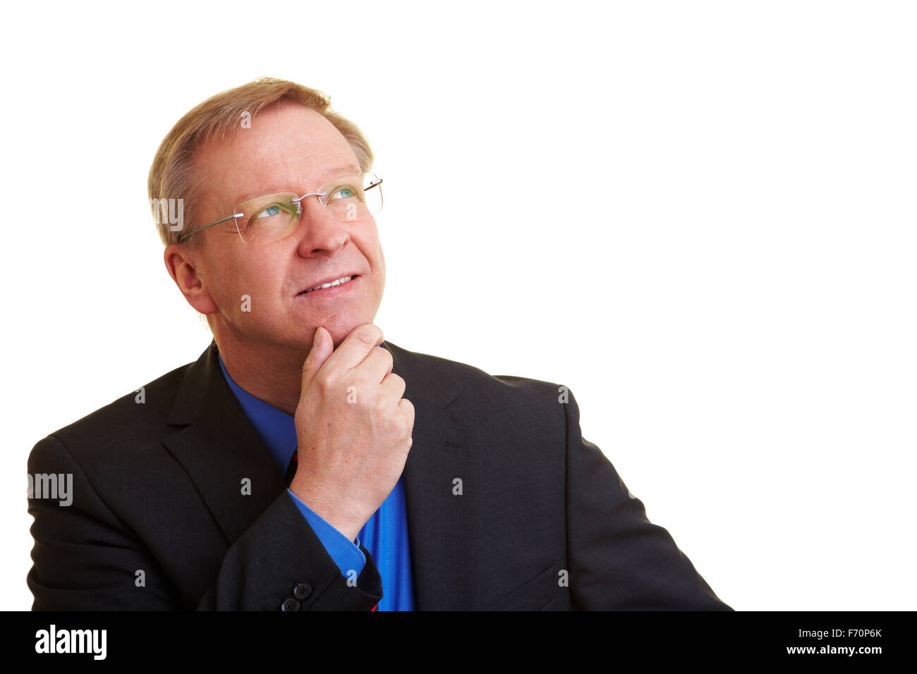 Senior businessman in a suit thinking while looking up Stock Photo - Alamy