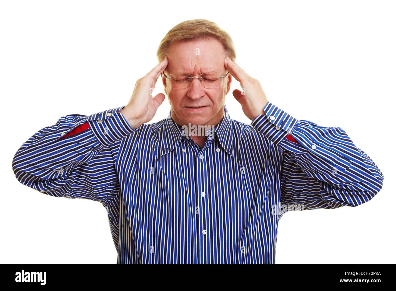Elderly man massaging his aching temples Stock Photo - Alamy