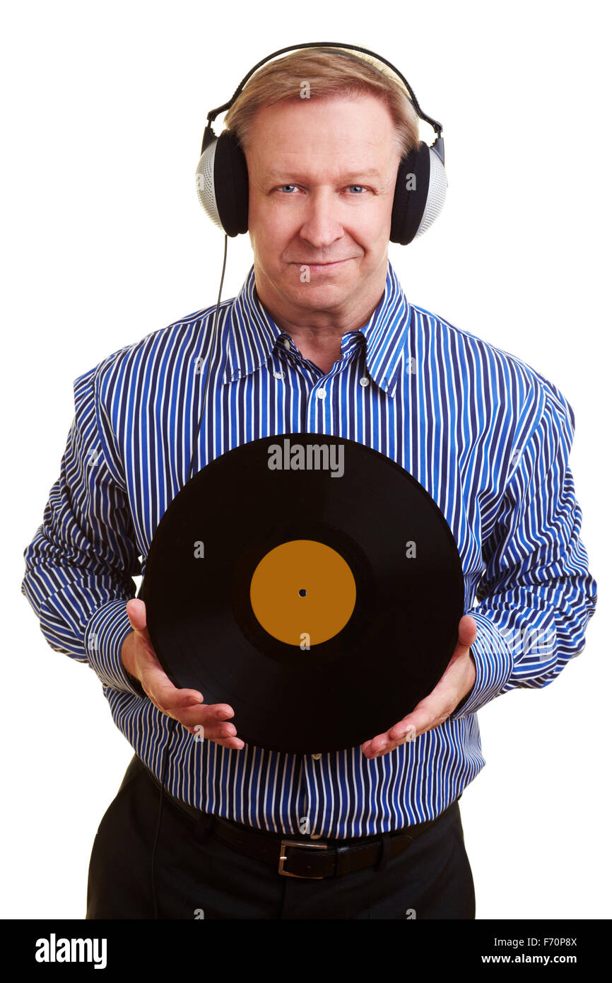 Elderly man with headphones holding an old record Stock Photo - Alamy