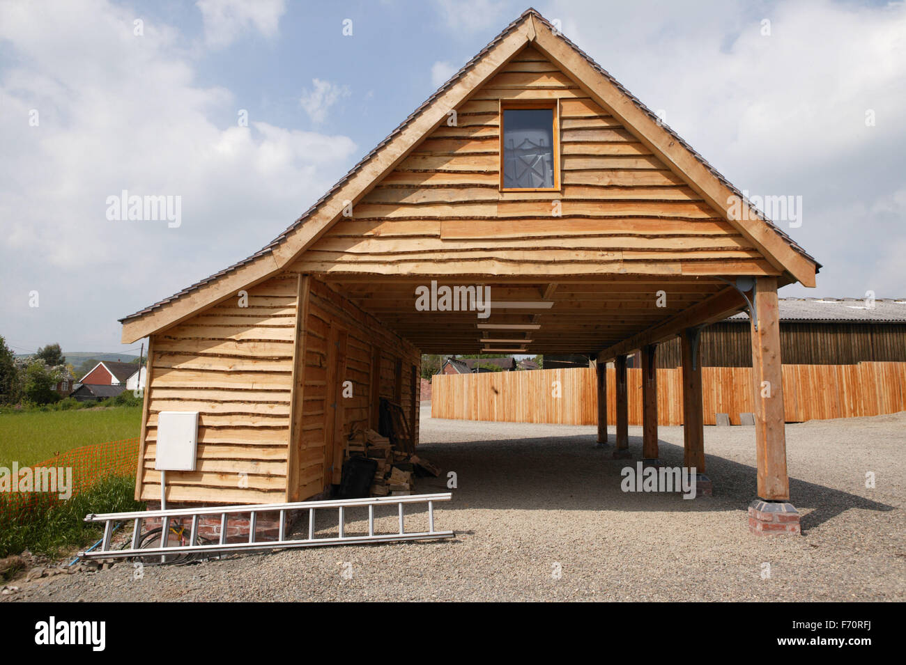 Wooden car port incorporating storage space at Eco House at The Wintles ...