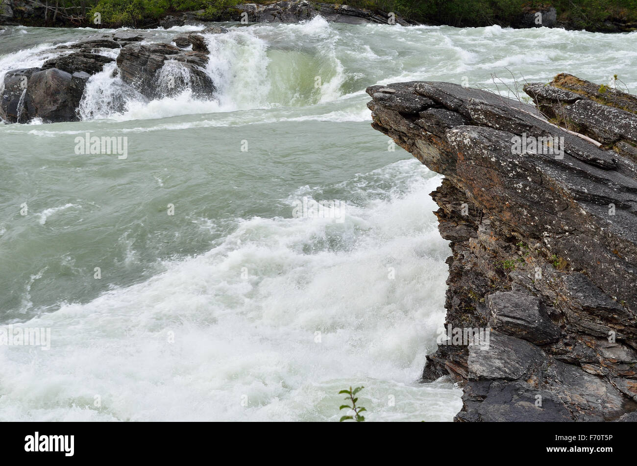 fast flowing flooded river current with violent waterfall Stock Photo ...