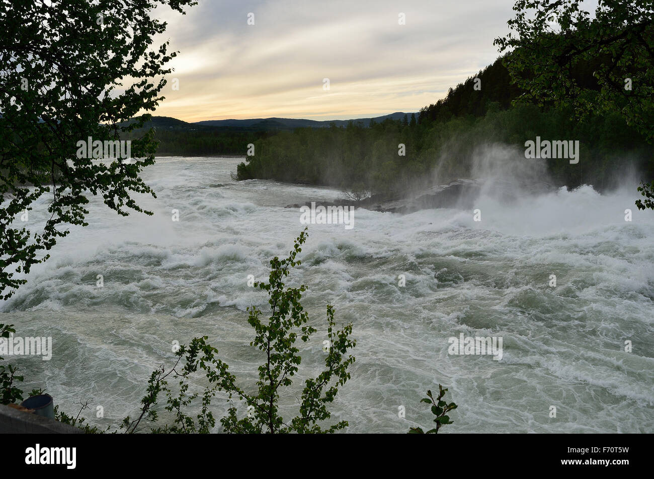 fast flowing flooded river current with violent waterfall Stock Photo ...