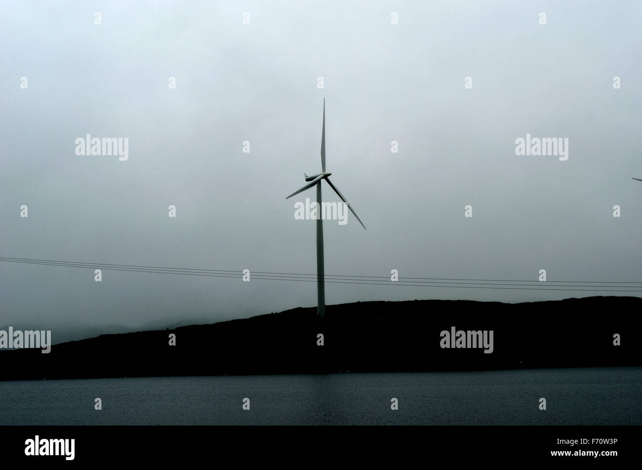 windmill on mountain top on dark and rain heavy summer day Stock Photo ...