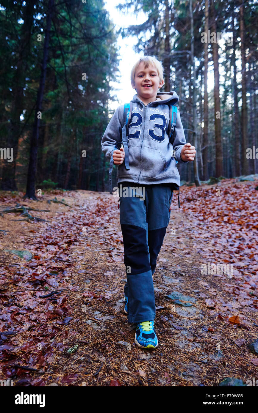 Full length portrait of a boy walking outdoor in a forest - wandering ...