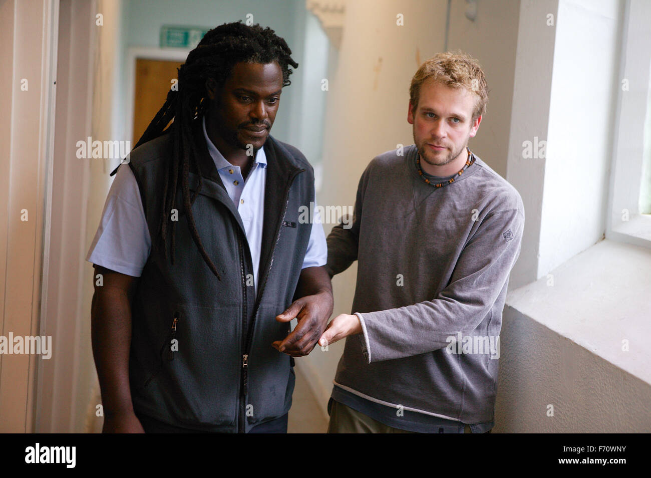 Mental health patient being escorted by a carer Stock Photo - Alamy