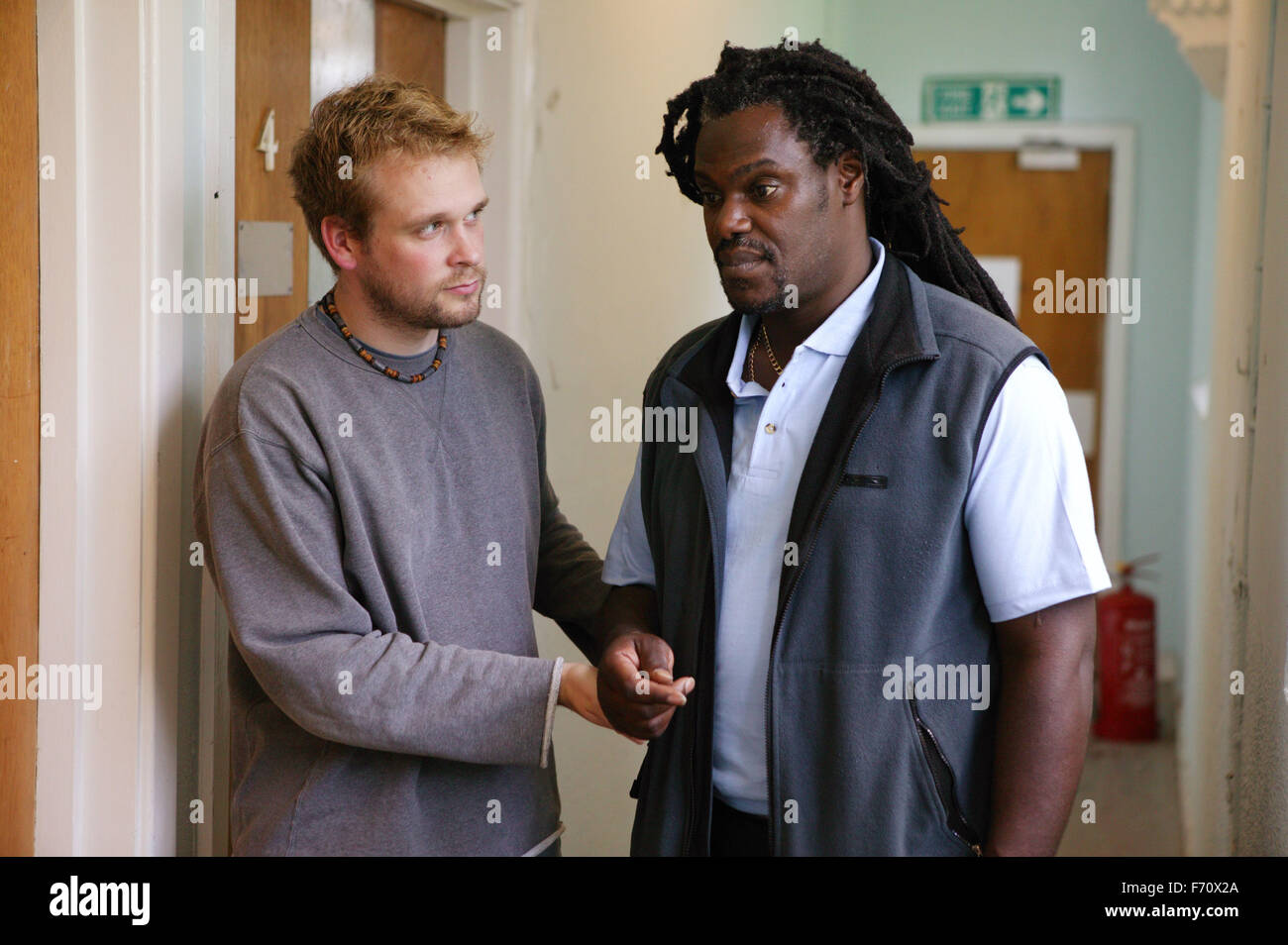 Mental health patient being escorted by a carer Stock Photo - Alamy