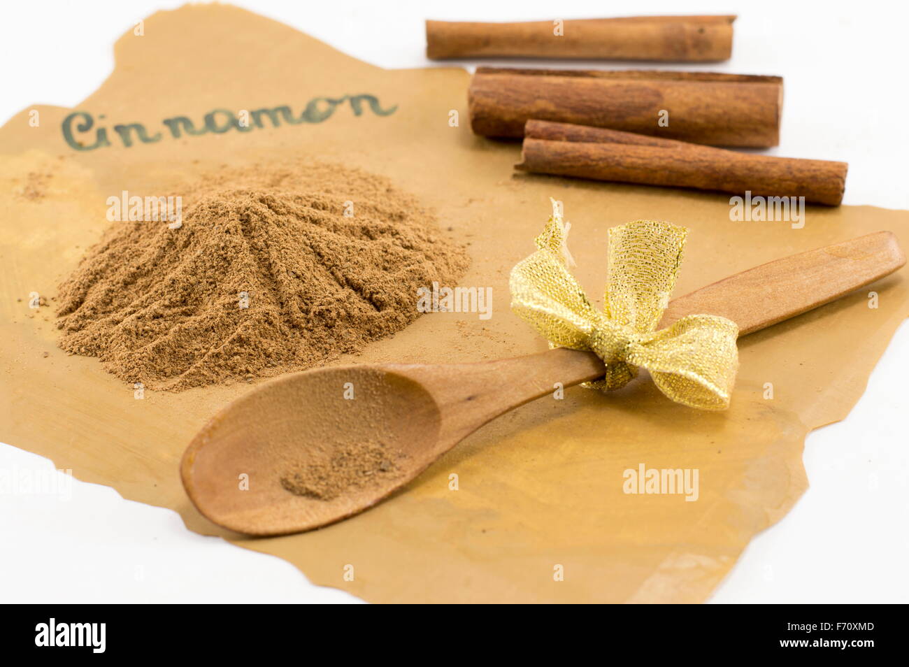 Various shapes of cinnamon on cooking paper against white background ...