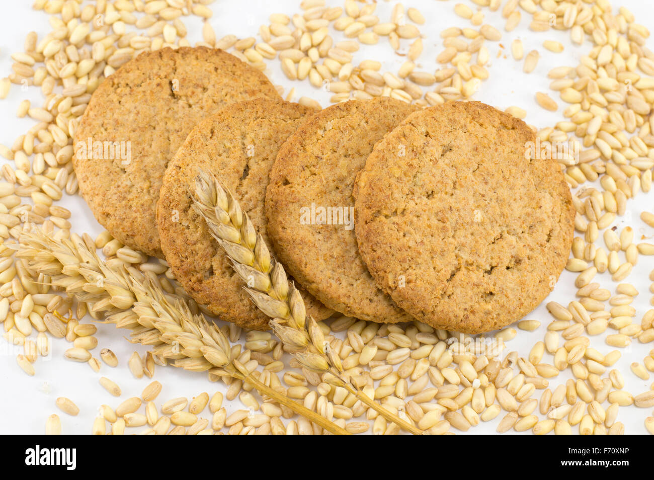 Integral cookies and yellow wheat plant on white background Stock Photo ...