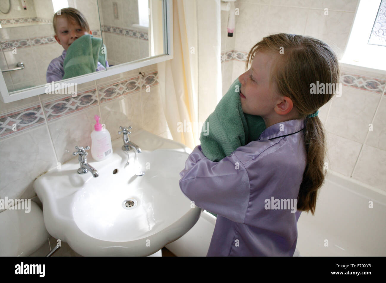 Girl washing her face Stock Photo - Alamy
