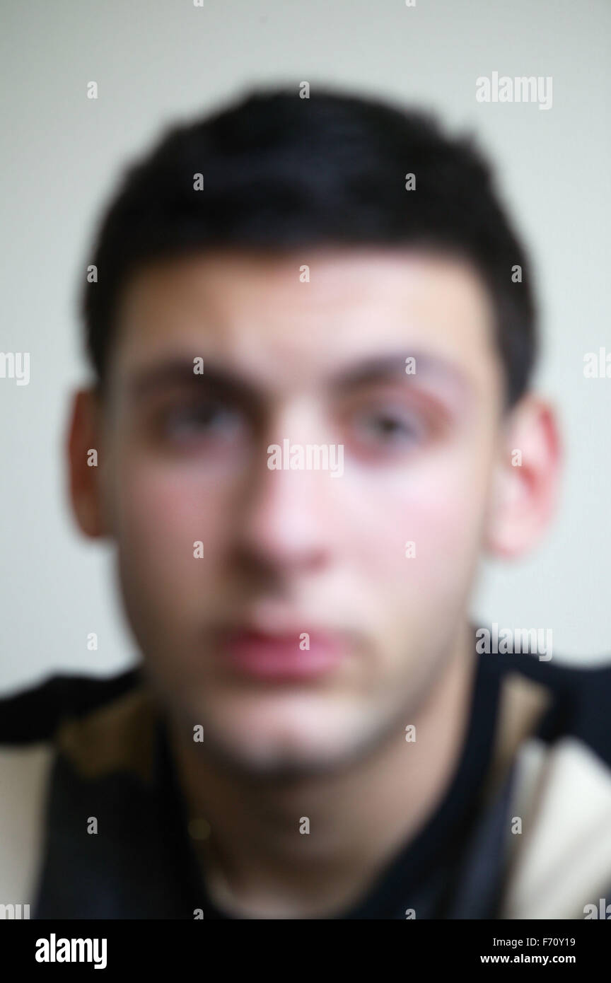 Blurred portrait of a young man; model released for use in HIV and Aids ...