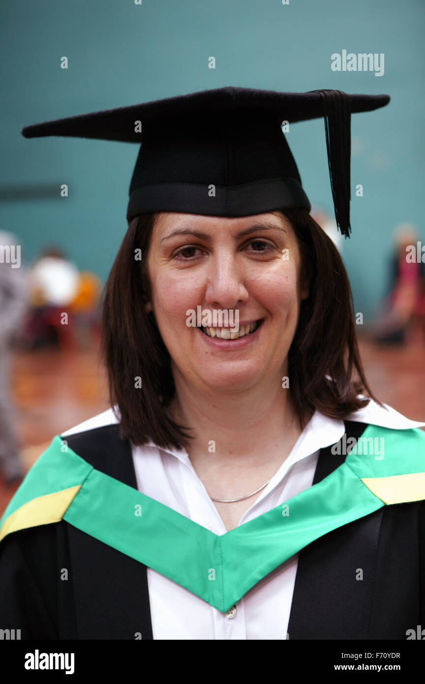 Portrait of woman in graduation gown Stock Photo - Alamy