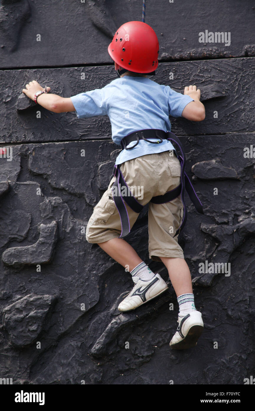 Young boy on a climbing wall part of a transformer vehicle; activities ...