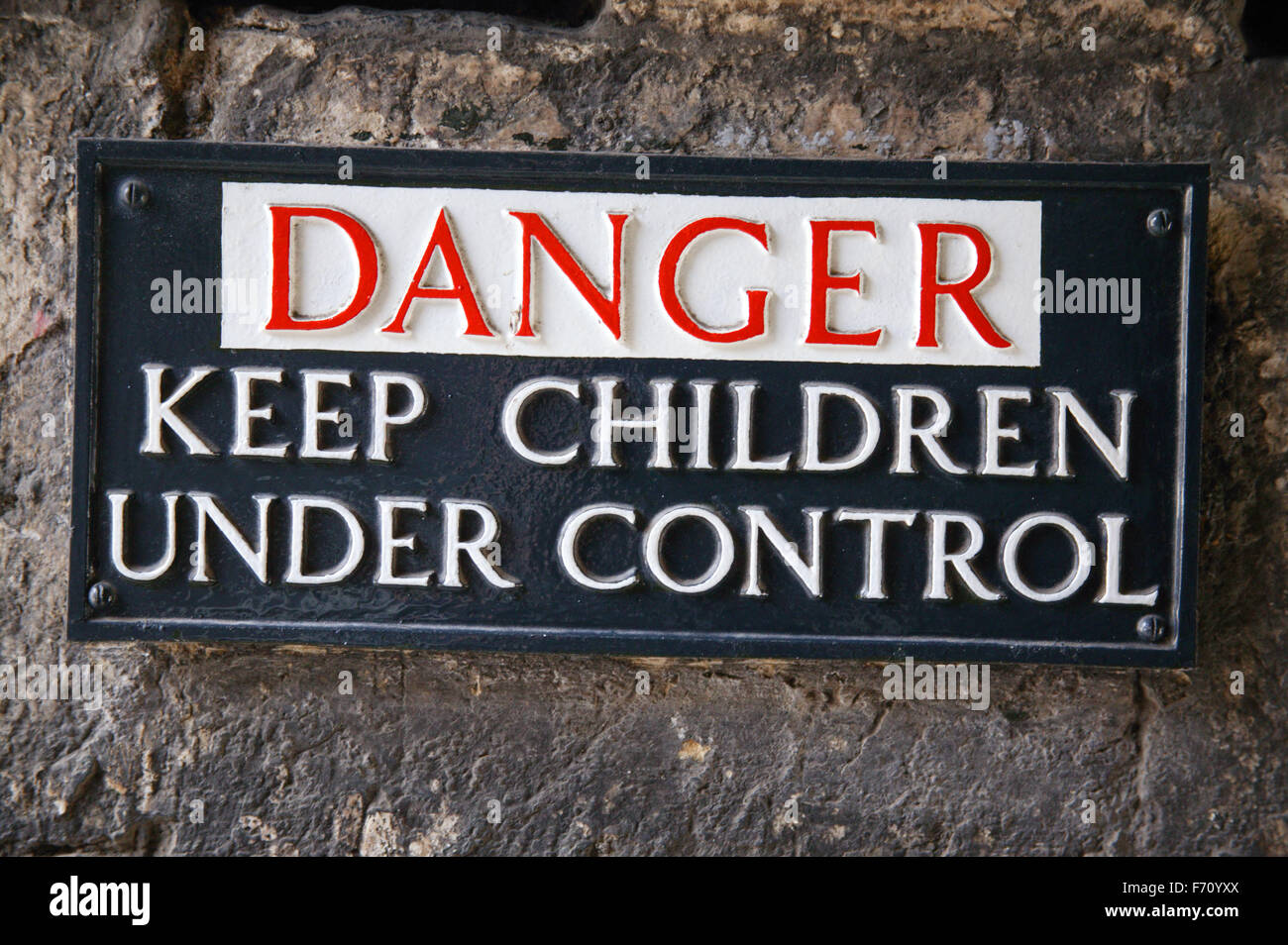 Warning sign; asking for children to be kept under control Stock Photo ...