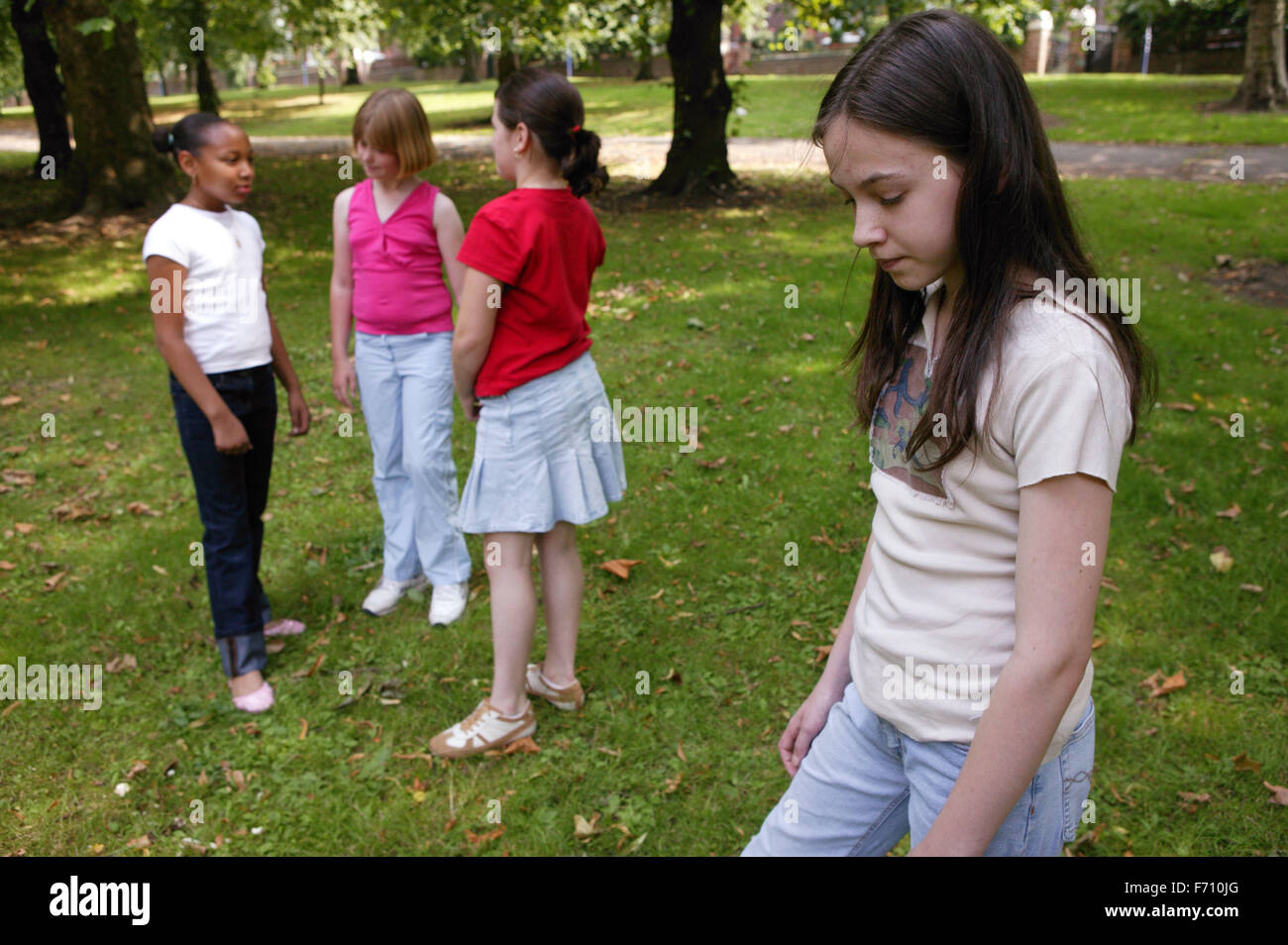 Three girls excluding their friend from their conversation Stock Photo ...