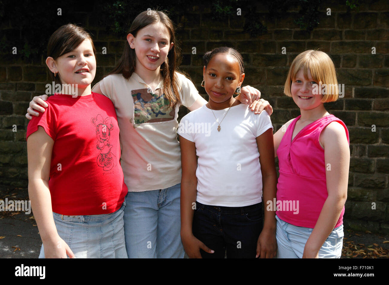 Four girls standing outside together Stock Photo - Alamy