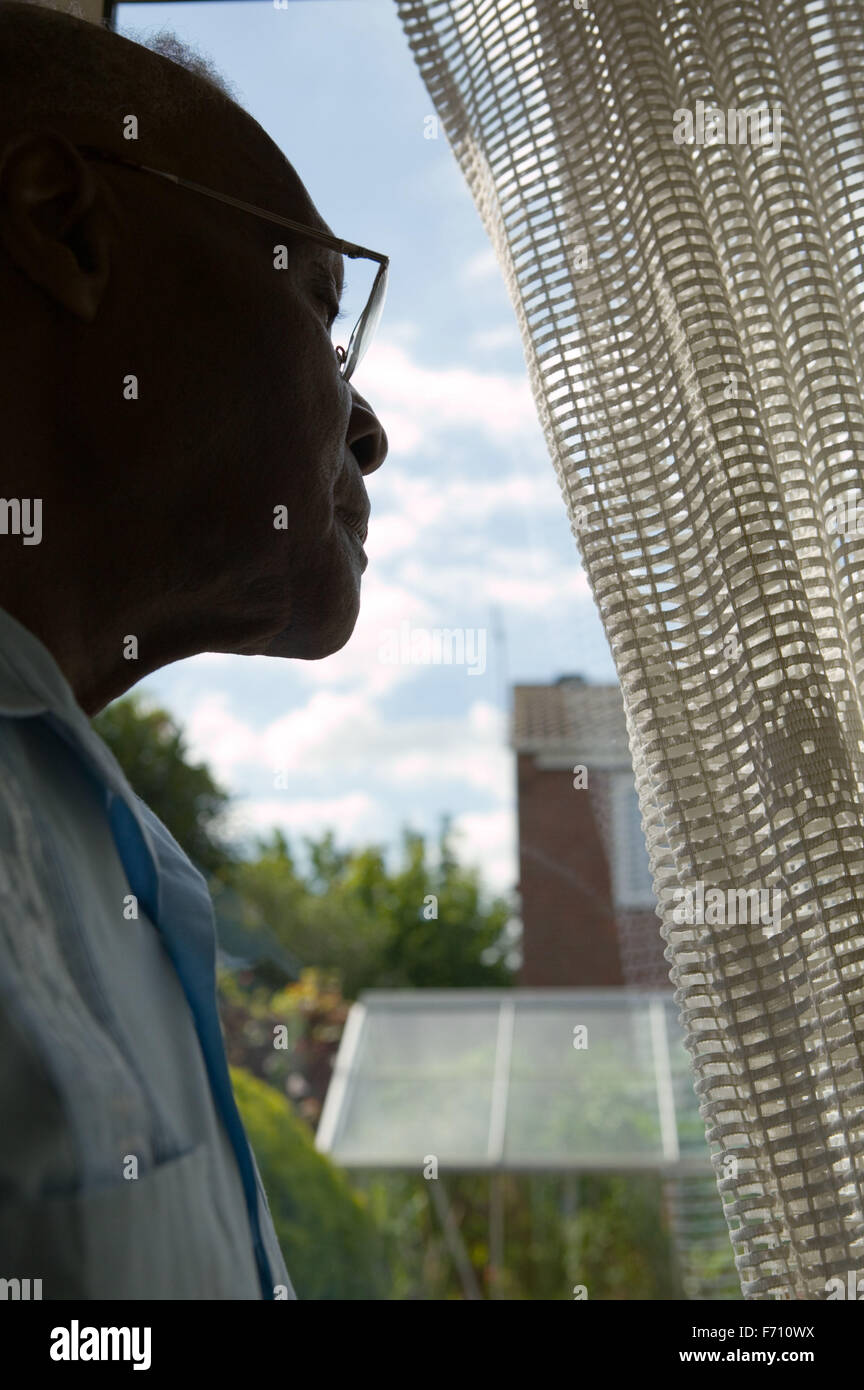 Old man looks out the window hi-res stock photography and images - Alamy