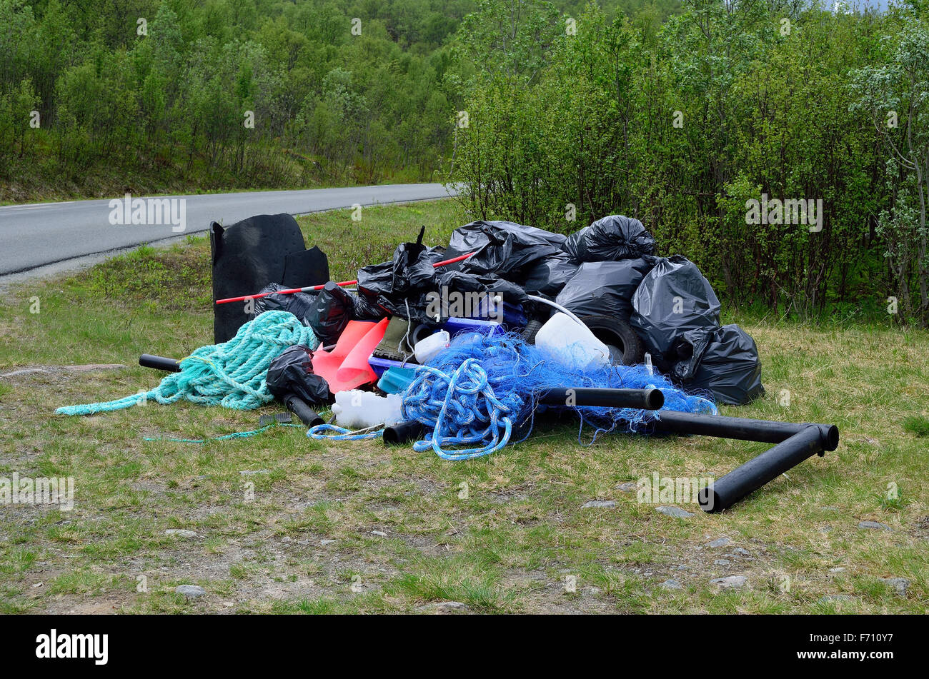 big garbage pile next to road Stock Photo - Alamy