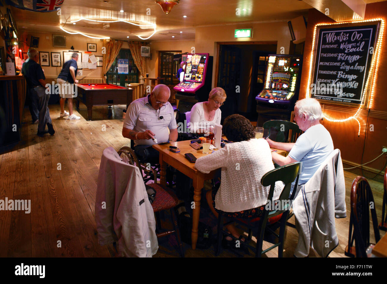 A group of people playing bingo at the local pub Stock Photo - Alamy