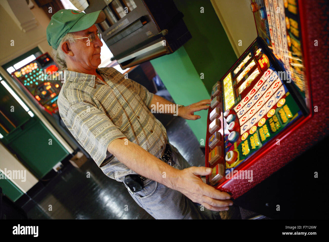 Man playing on a fruit machine in a pub Stock Photo - Alamy