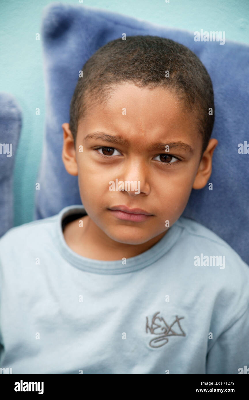 Portrait of a young boy looking upset Stock Photo - Alamy