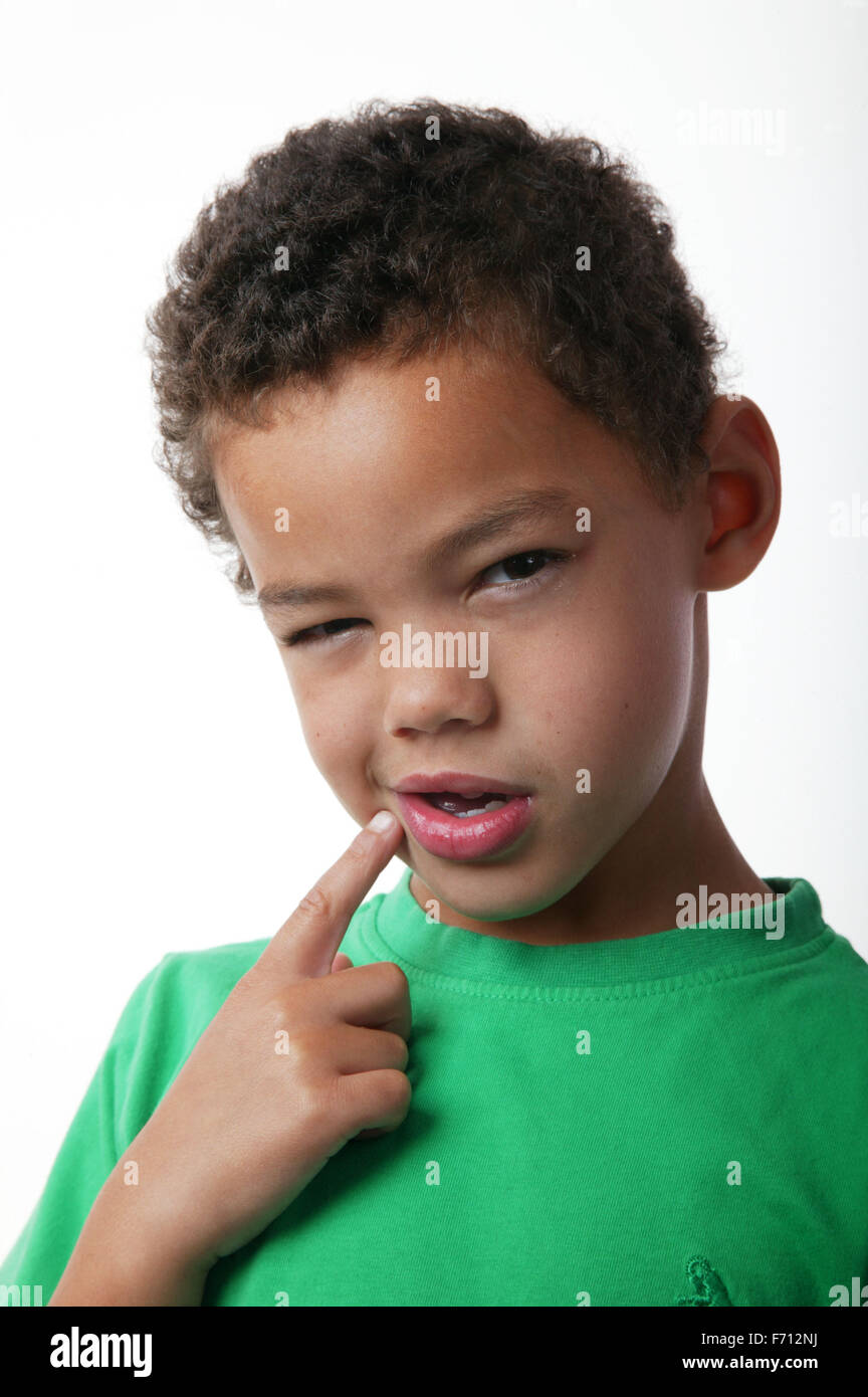 Portrait of a young boy looking puzzled Stock Photo - Alamy